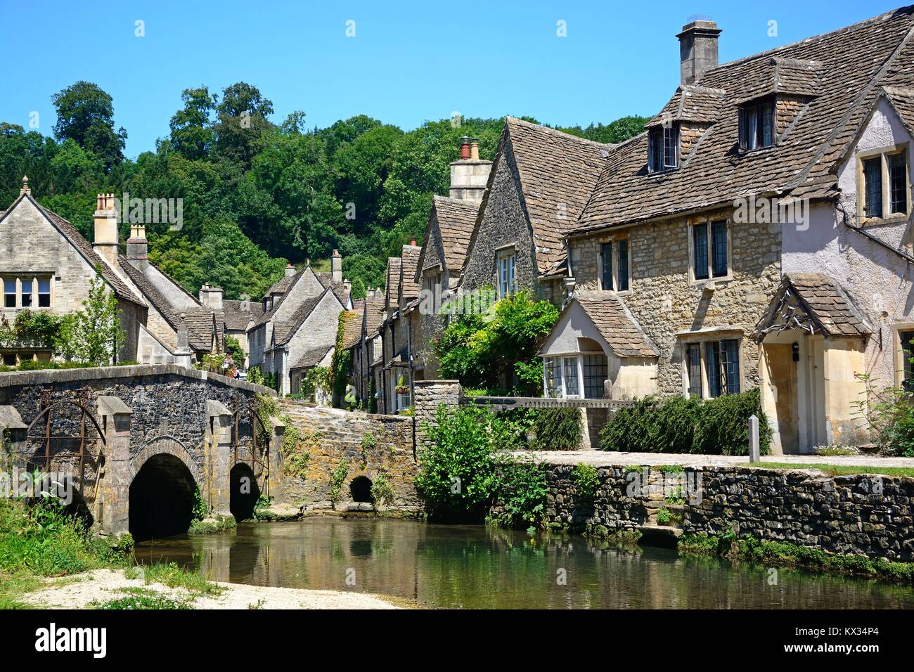 Stone bridge over the river Bybrook with cottages to the rear, Castle ...