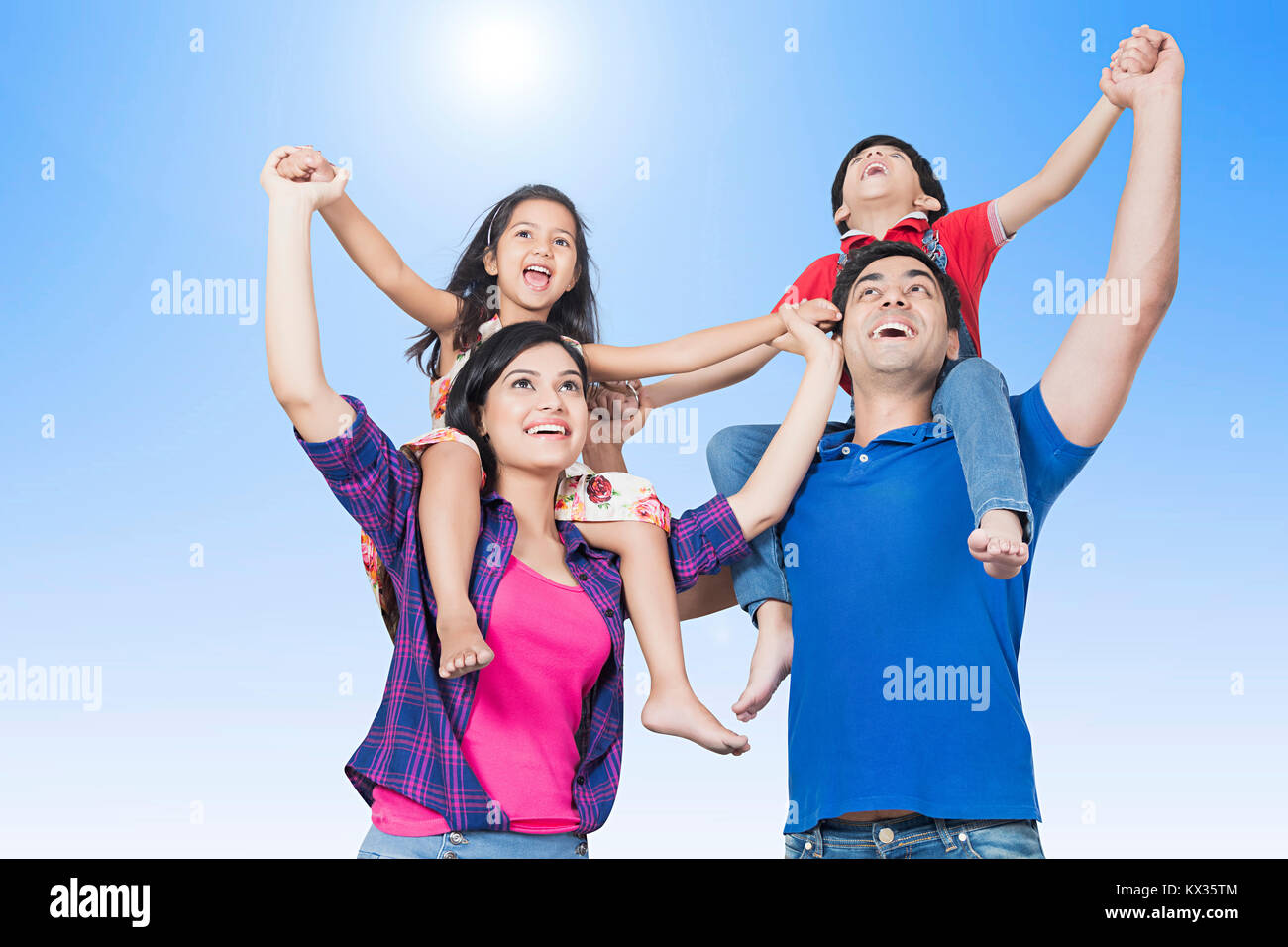 Parents carrying kids on shoulders hi-res stock photography and images ...