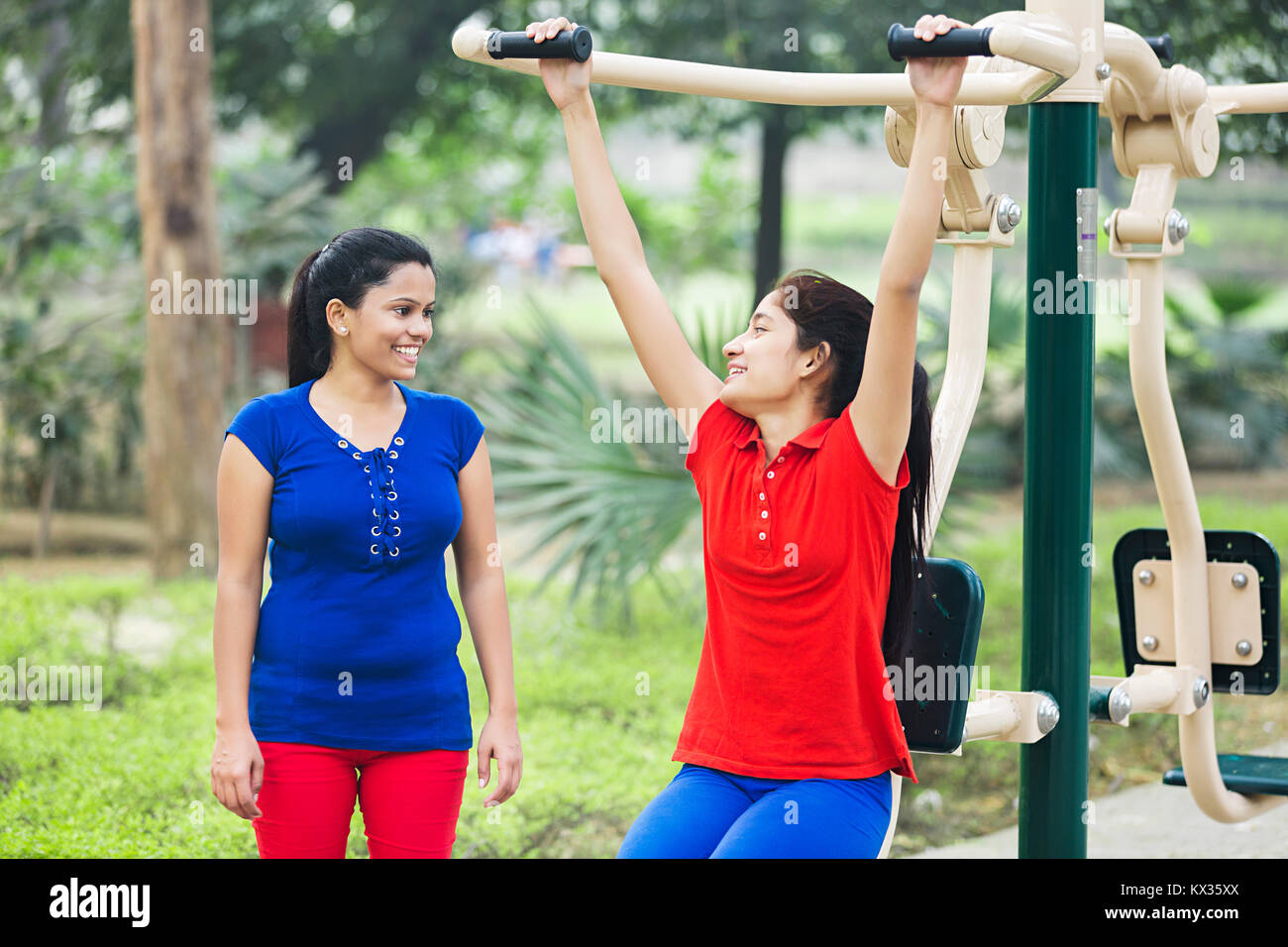 Young Girls Park Gym Equipment Exercising Workout Stock Photo - Alamy