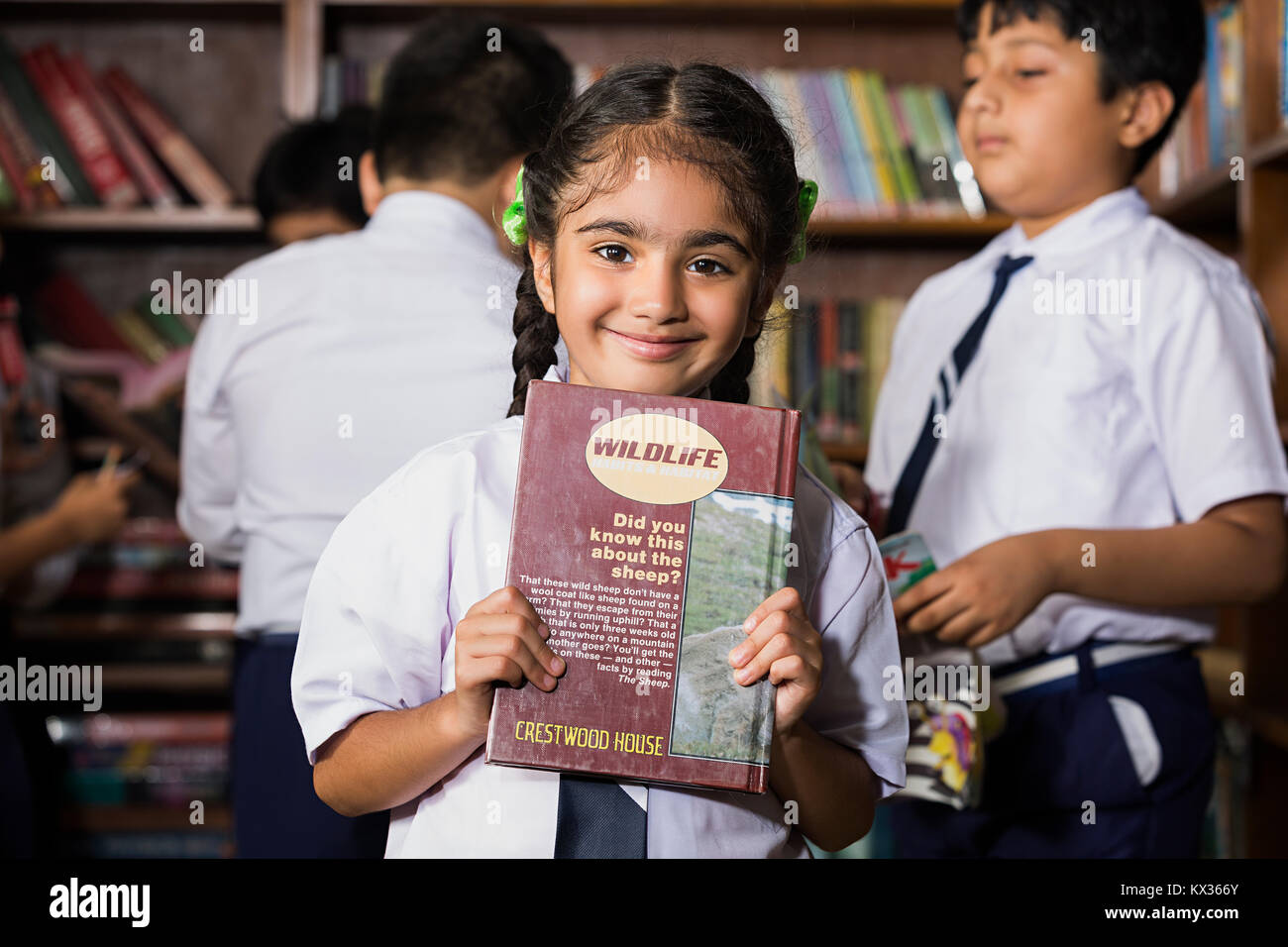 1 Indian School Kid Girl Student Showing Book In Library Smiling Stock ...