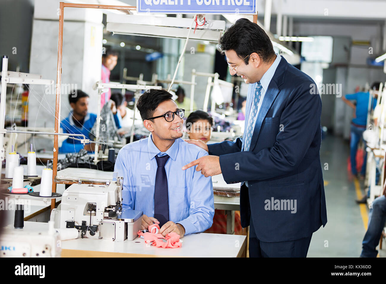 Factory-Boss Showing Mobile Phone And Workers Tailors Working In ...
