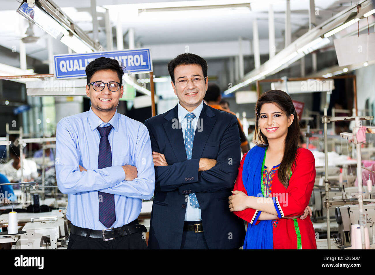 Factory-Owner And Woman Tailor With Workers Working In Sewing Workshop ...