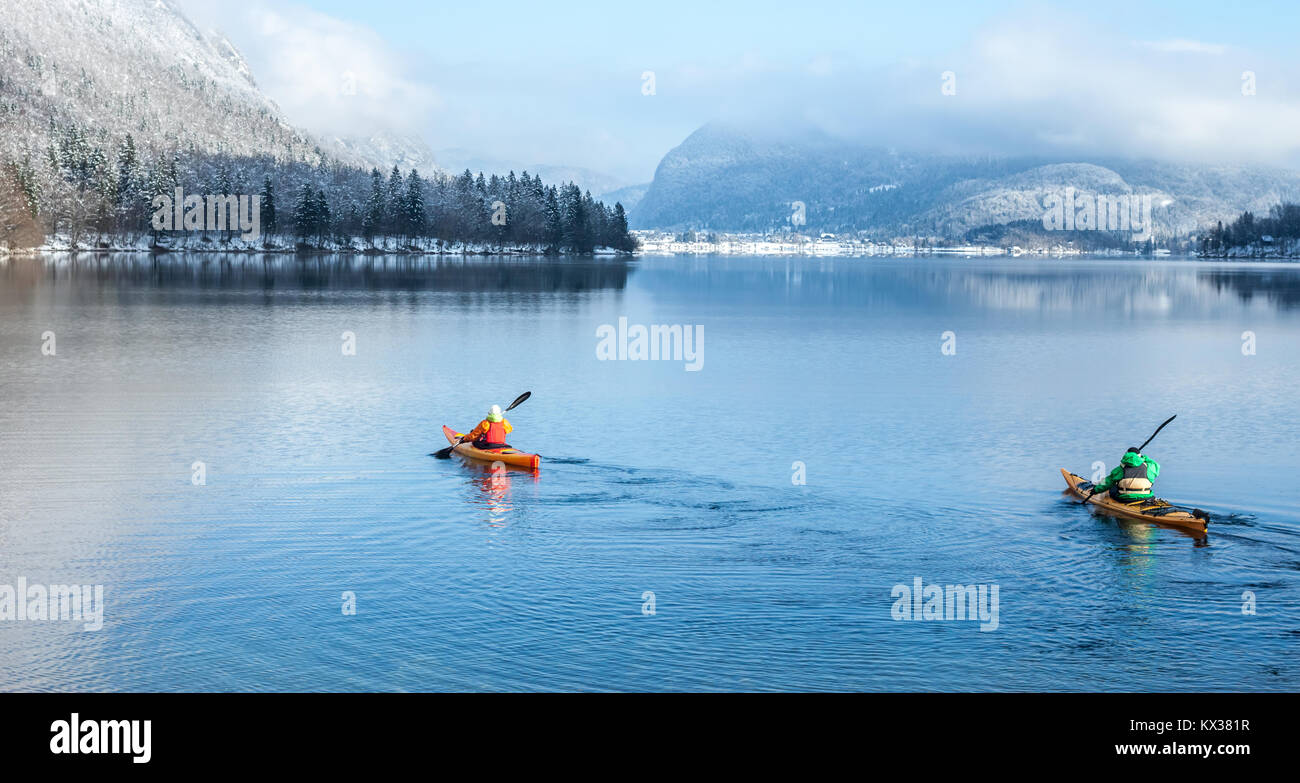 two people kayaking in the winter among mountains Stock Photo - Alamy