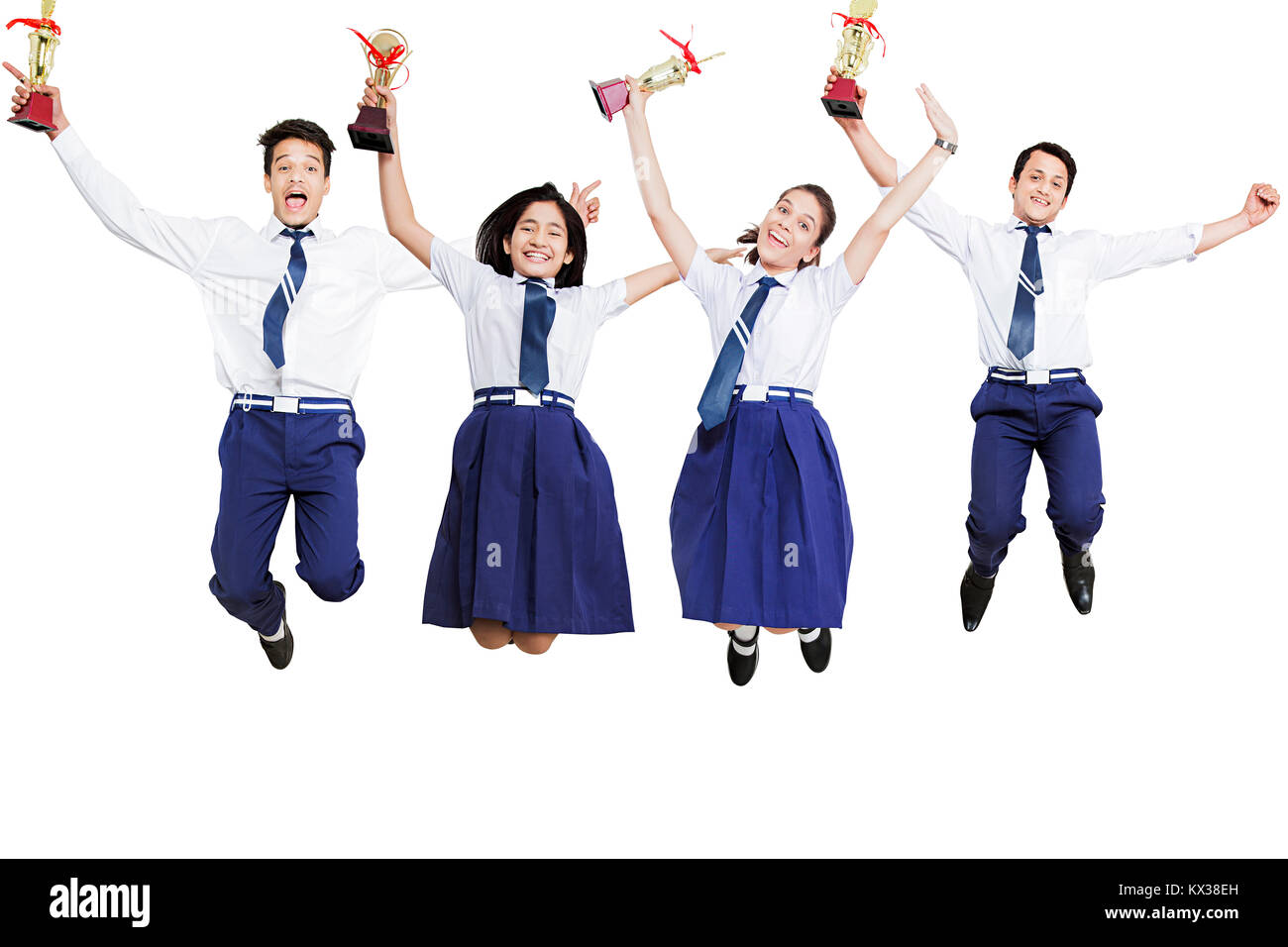 4 Indian School Students Friends Jumpping Showing Victory Trophy ...