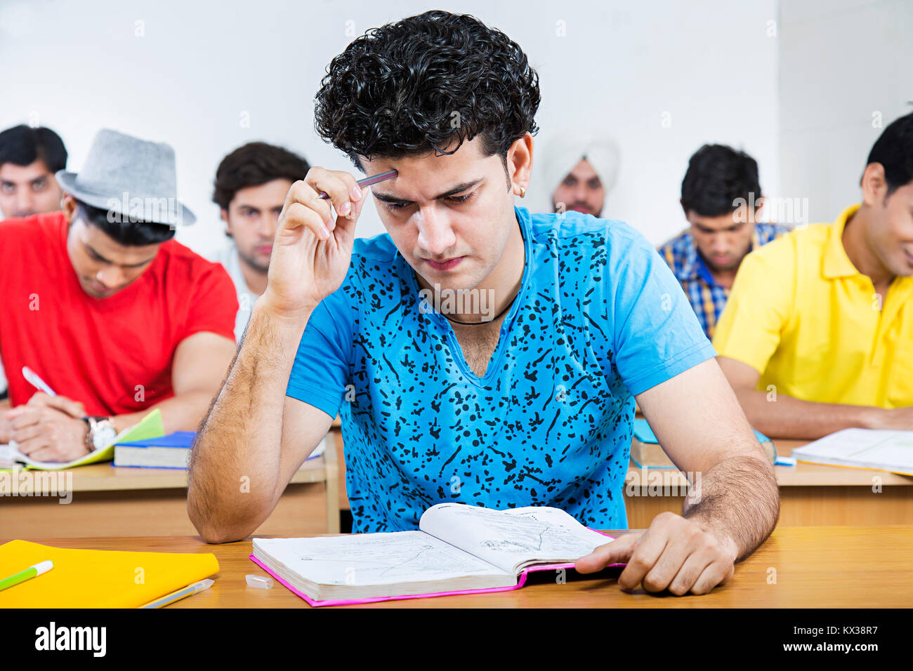 Indian college boy holding book hi-res stock photography and images - Alamy
