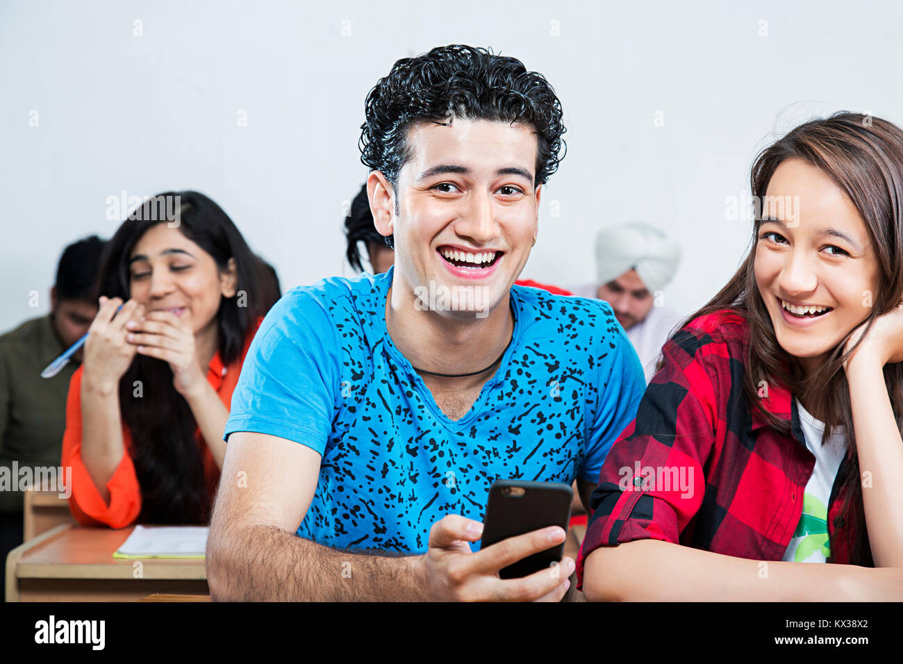 Indian College Friend Messaging Cell Phone In Classroom Stock Photo - Alamy