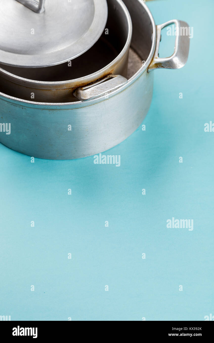 Used home saucepan with scratches on blue paper background Stock Photo ...