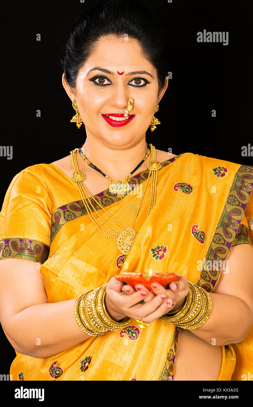 Indian woman holding oil lamp hi-res stock photography and images - Alamy