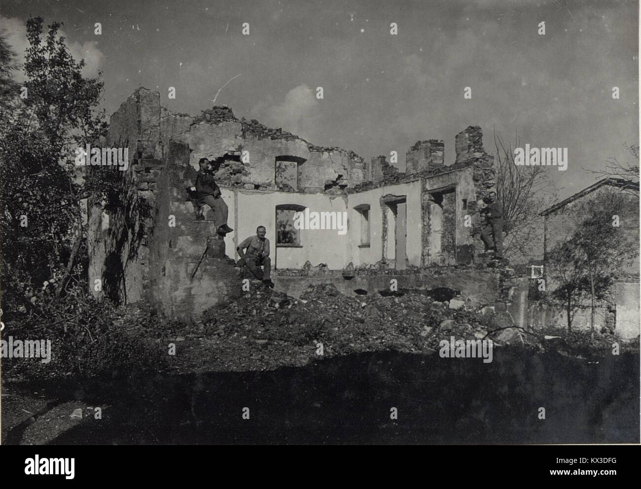 The photograph depicts a house destroyed by an aerial bomb ...