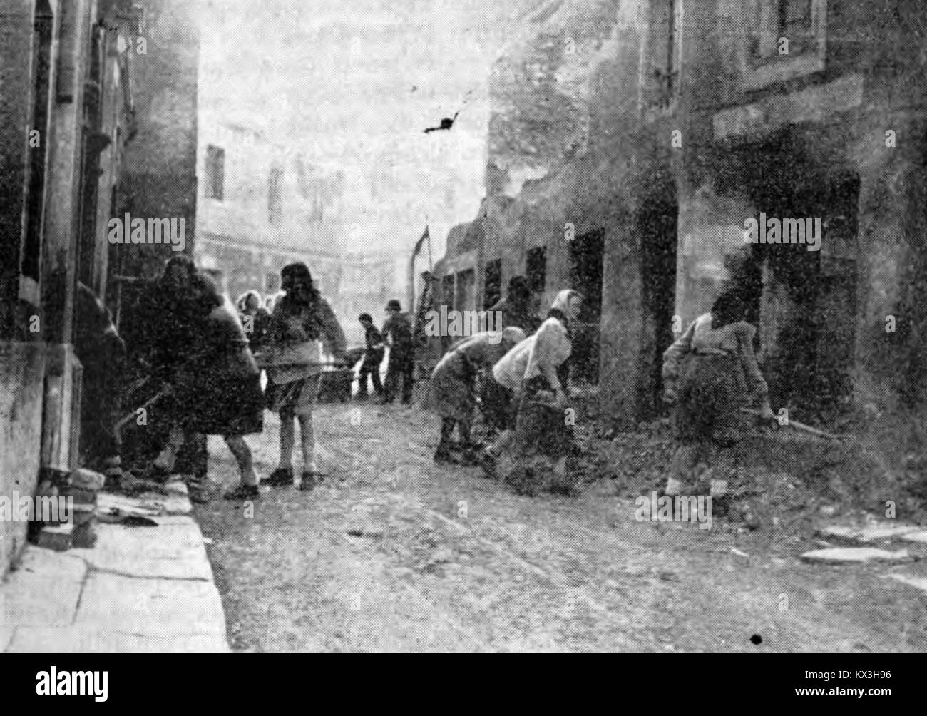 Photograph showing rubble clearing in bombed Cerknem, documenting post ...