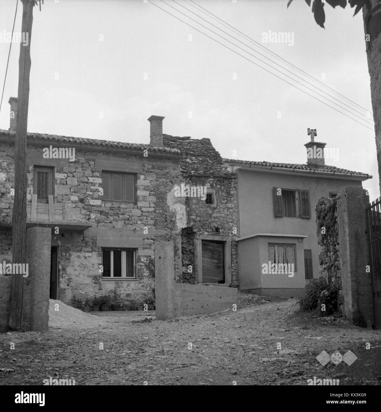 This 1969 photograph shows a Gothic-style building situated between two ...