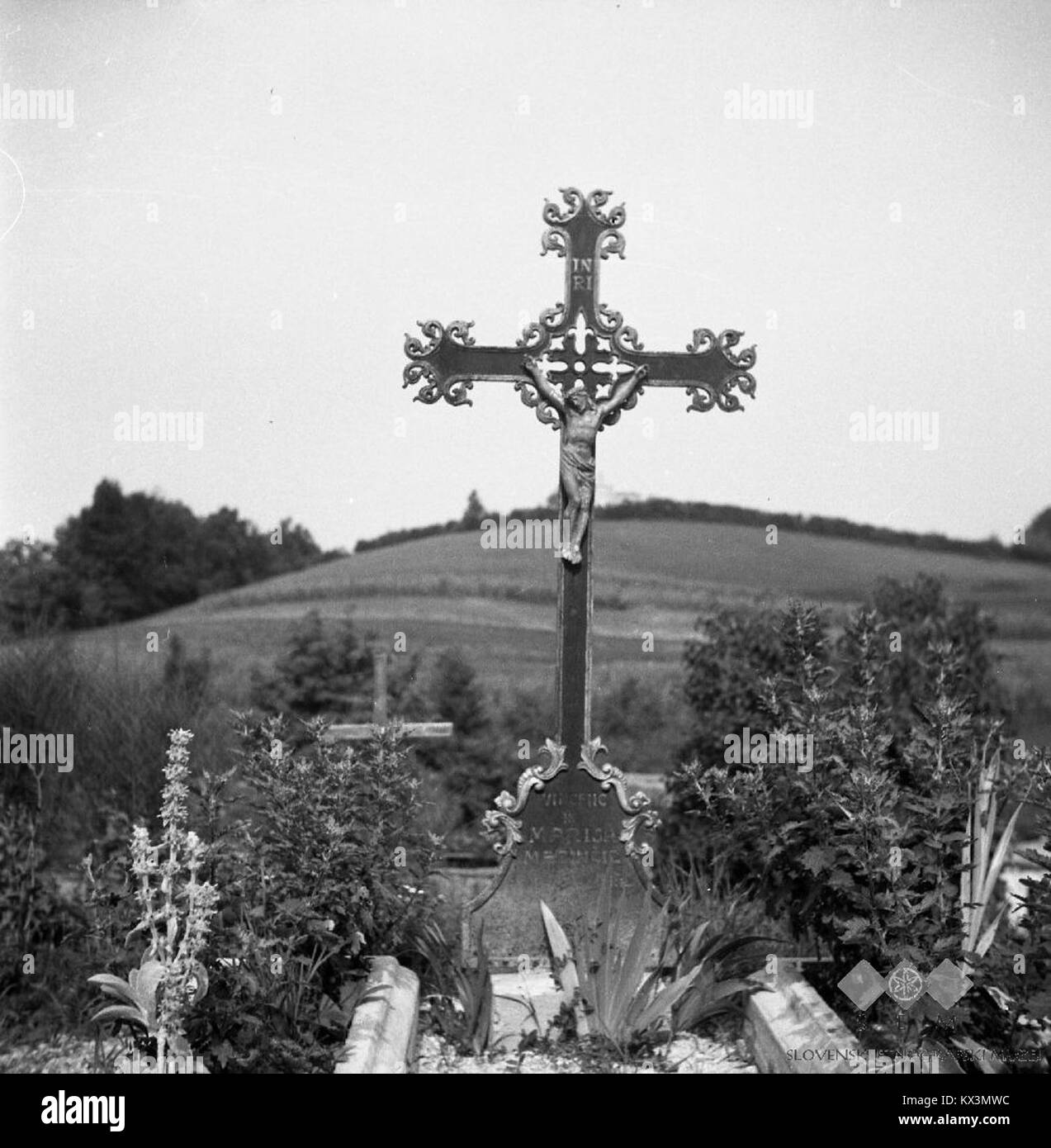A metal cross at the cemetery in Žužemberk, Slovenia, likely produced ...