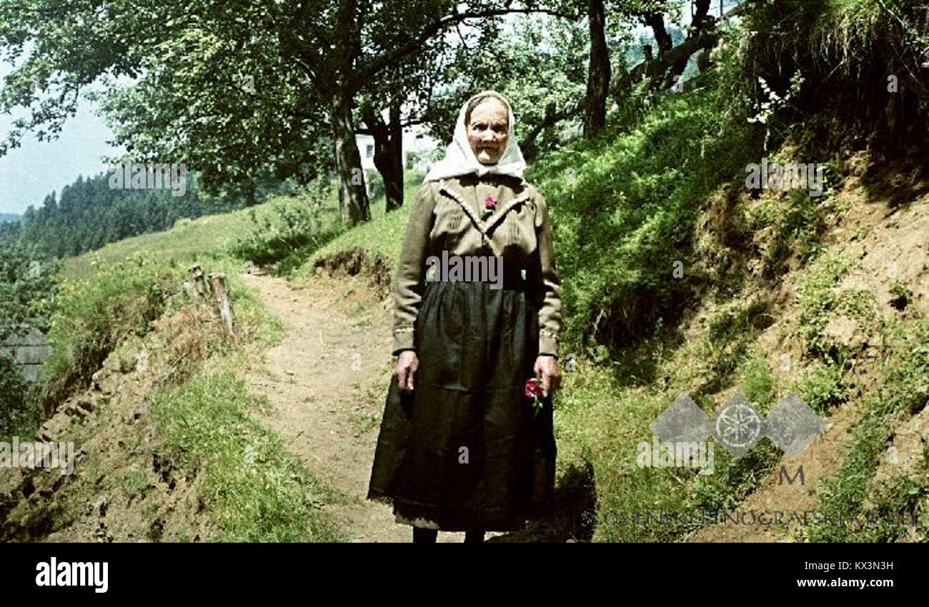 This photograph from 1963 depicts a woman in traditional Sunday attire ...