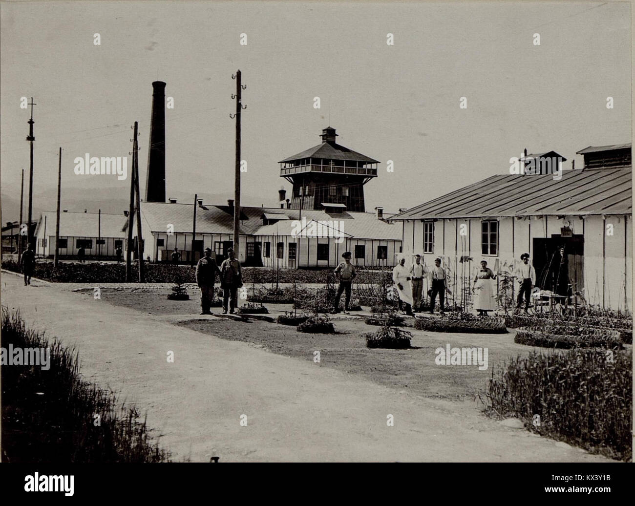 This image depicts a steam laundry and water tower, showcasing ...