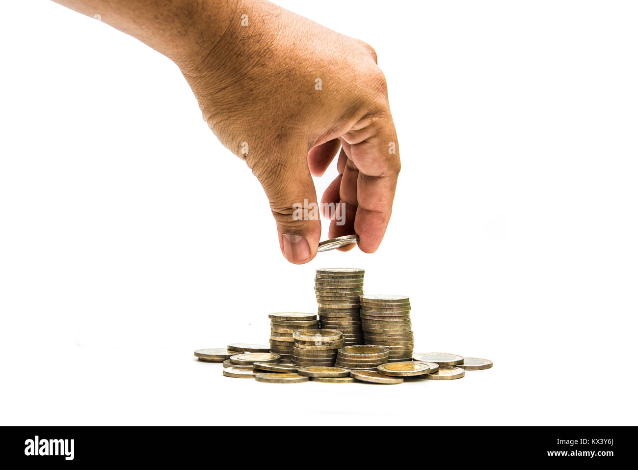 coin stacks with hand on white background Stock Photo - Alamy