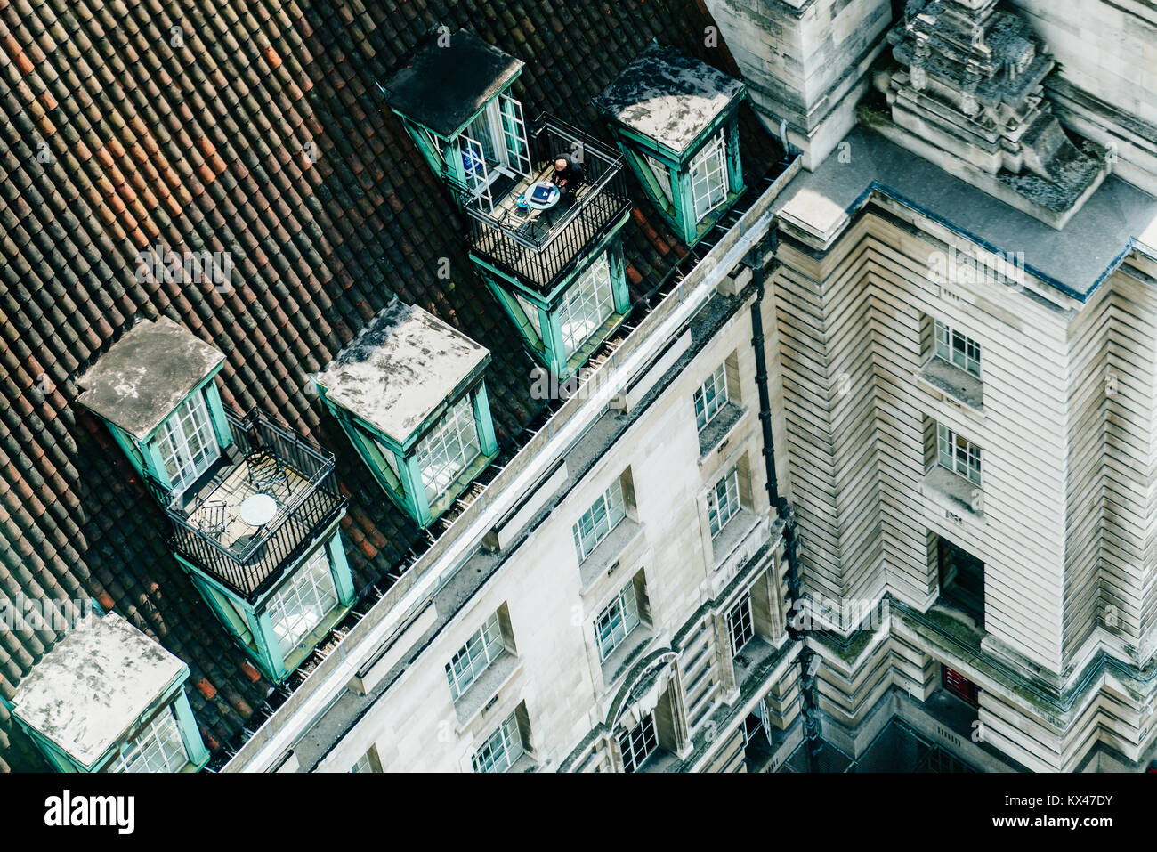 Working in the balcony Stock Photo - Alamy