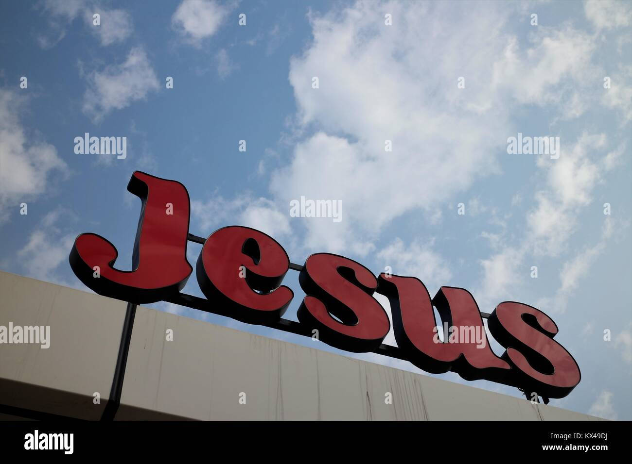 Red Jesus sign on blue sky Stock Photo - Alamy