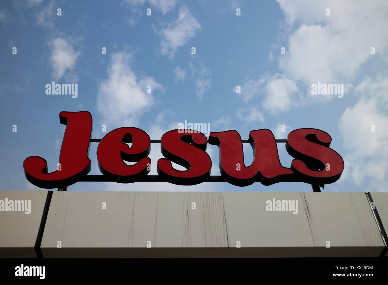 Red Jesus sign on blue sky Stock Photo - Alamy