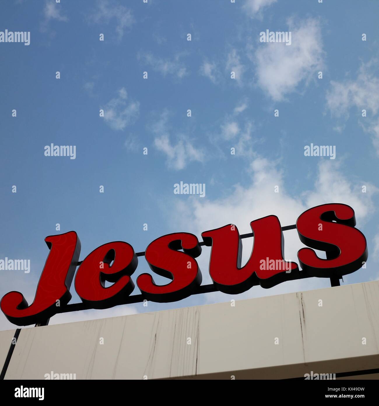 Red Jesus sign on blue sky Stock Photo - Alamy