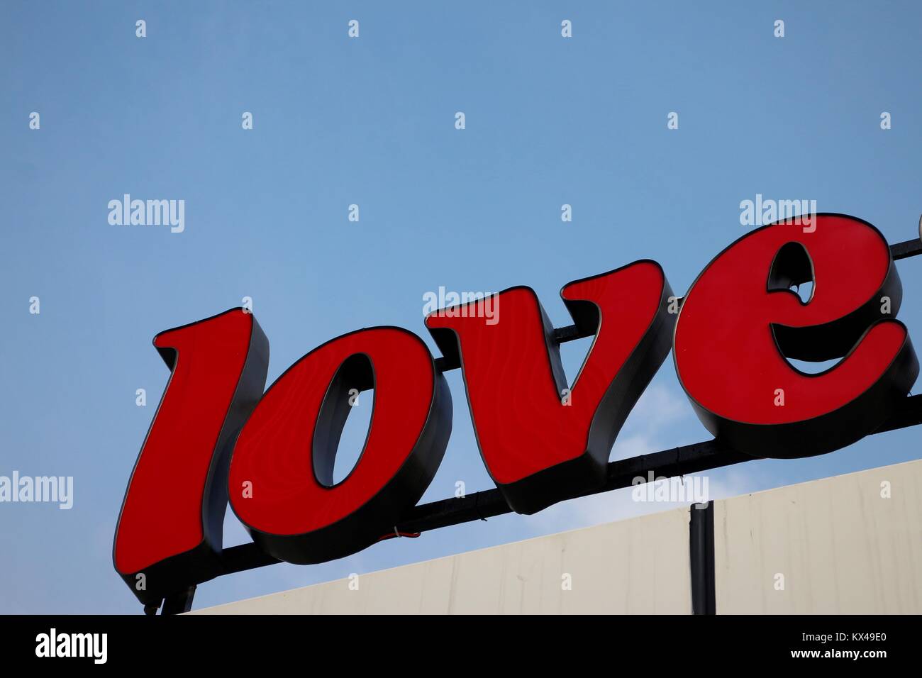Red 'Love' sign on blue sky Stock Photo - Alamy