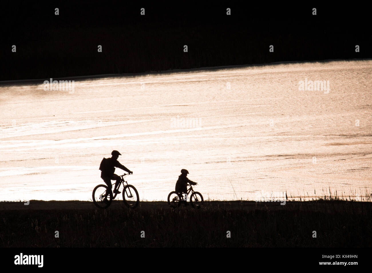 Father and son riding bike Stock Photo - Alamy