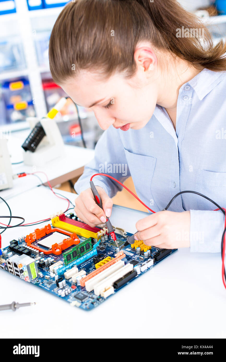 Young woman in electronics repair service center Stock Photo - Alamy