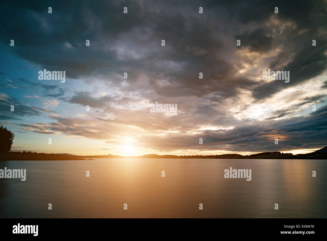 Sunset over lake Stock Photo - Alamy