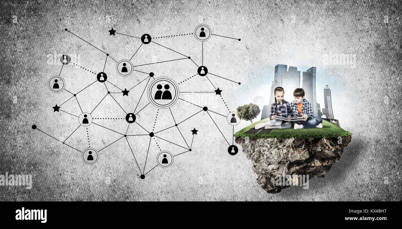 Two kids of school age with book exploring this great world Stock Photo ...