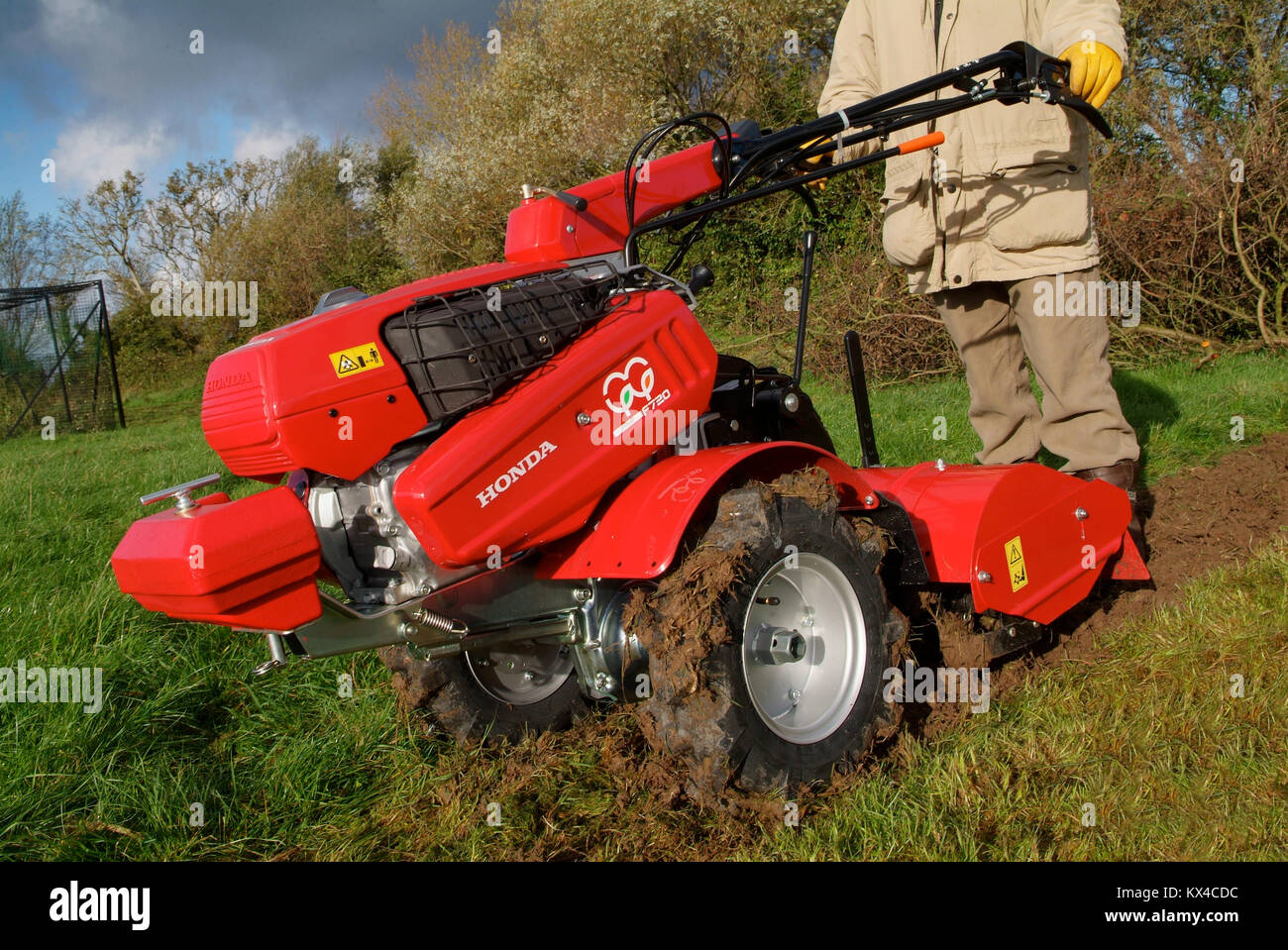 Rotavators in action in a country garden Stock Photo - Alamy