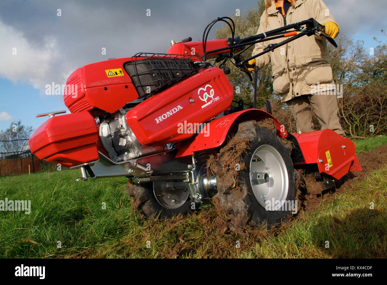 Rotavators in action in a country garden Stock Photo - Alamy