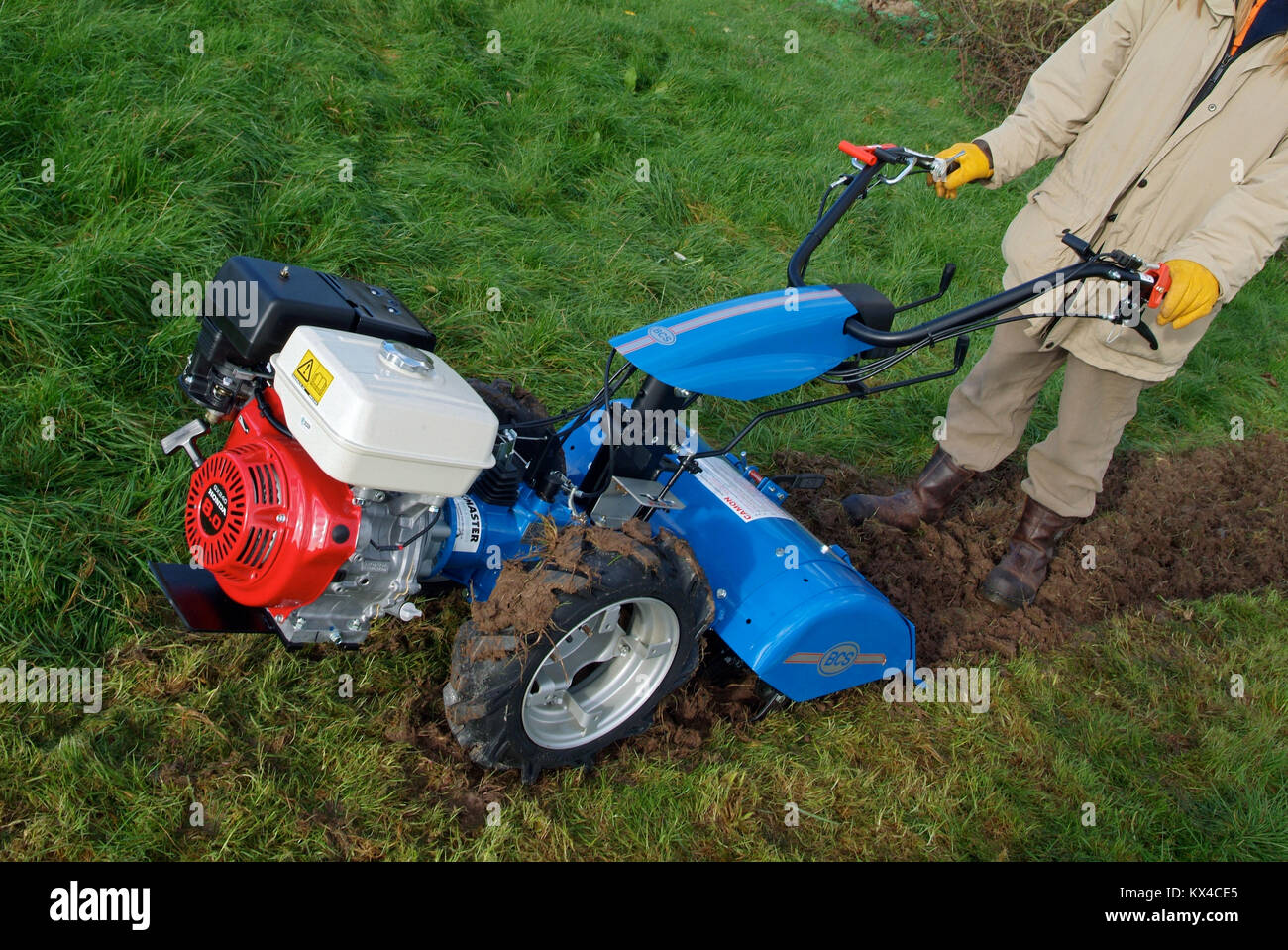 Rotavators in action in a country garden Stock Photo - Alamy