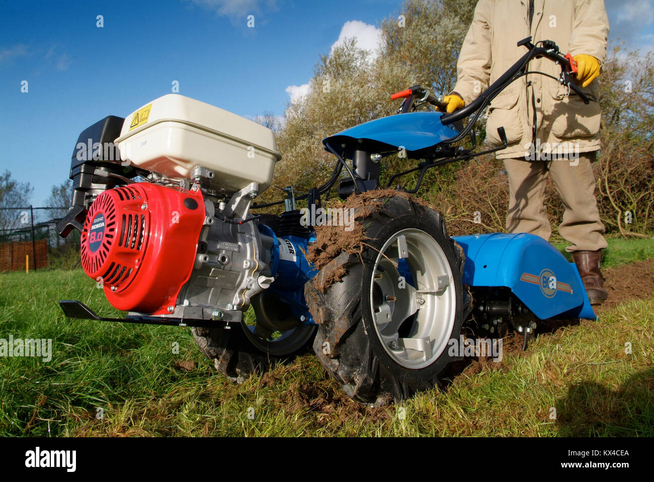 Rotavators in action in a country garden Stock Photo - Alamy