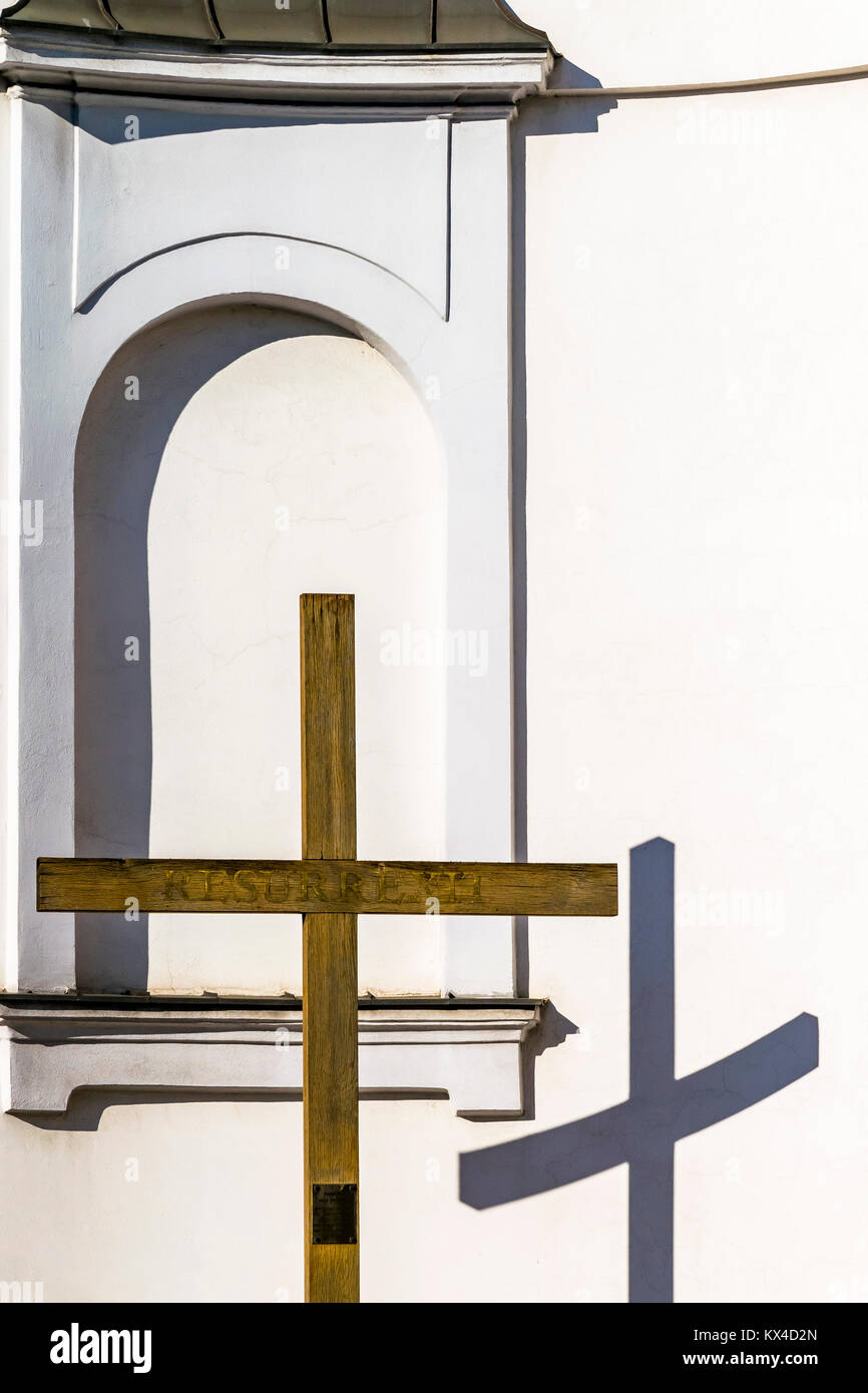 Wooden cross and church wall, Christian religious theme. Reflection of ...