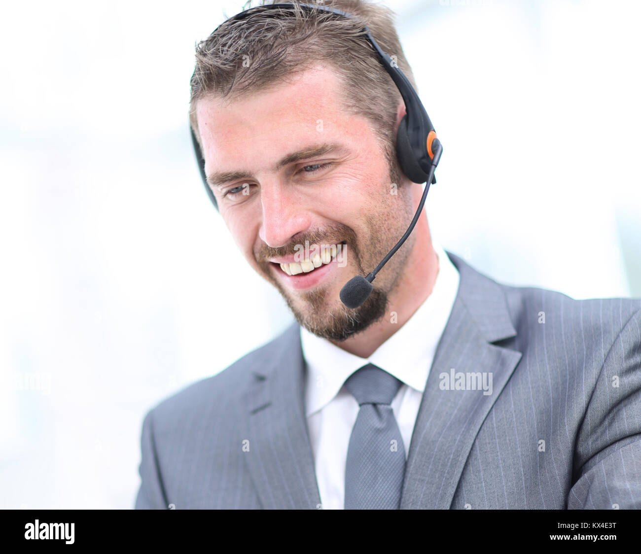 Happy man working at callcenter, using headset Stock Photo - Alamy