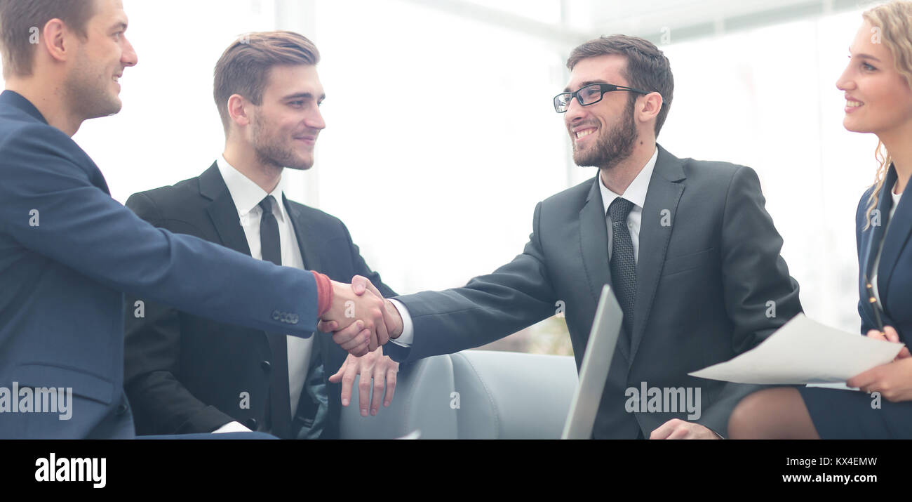 Handshake between businesspeople in a modern office Stock Photo - Alamy