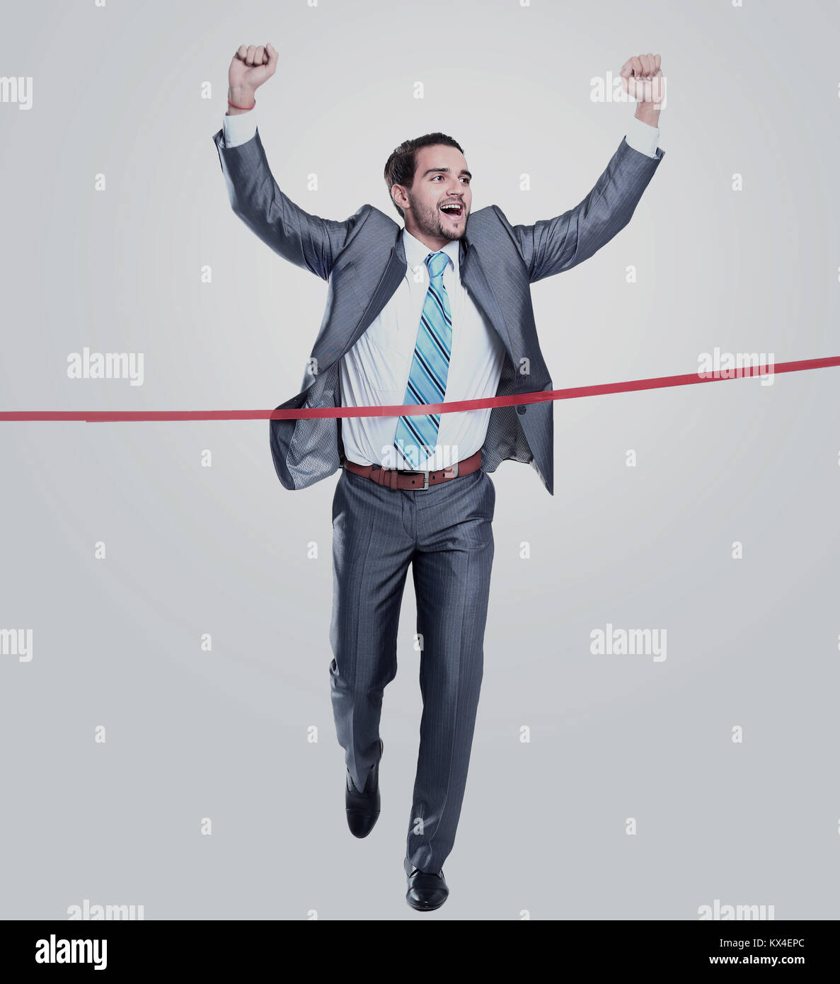 Happy businessman running through finishing line. Isolated on white ...