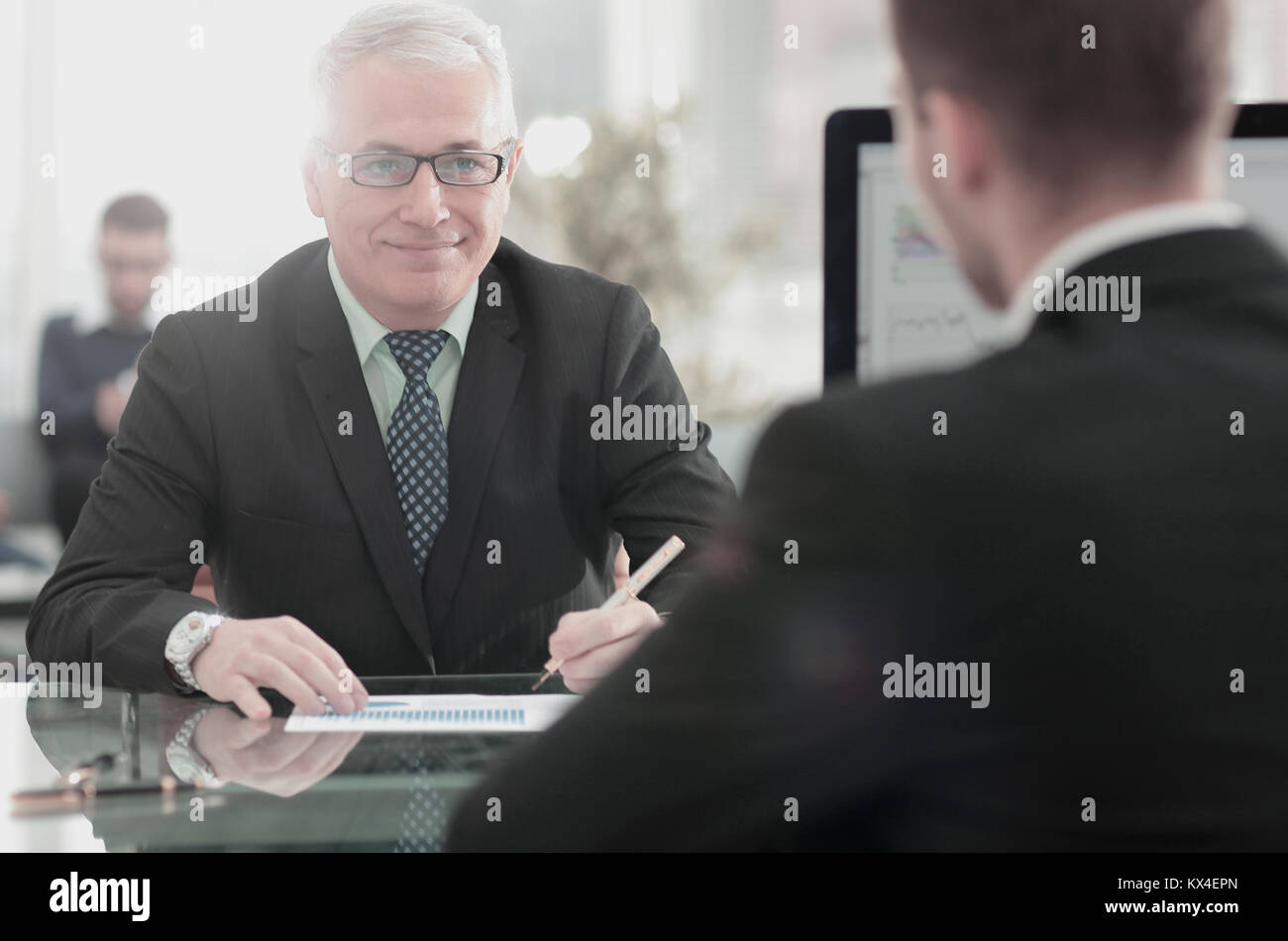 Two employees discussing electronic data at meeting Stock Photo - Alamy