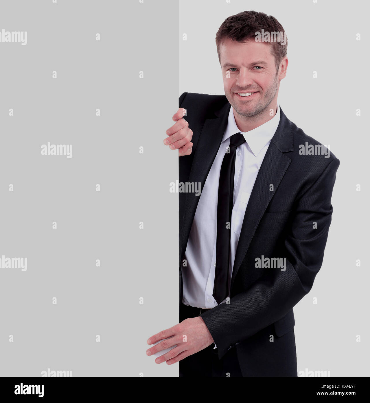Portrait of businessman showing banner Stock Photo - Alamy