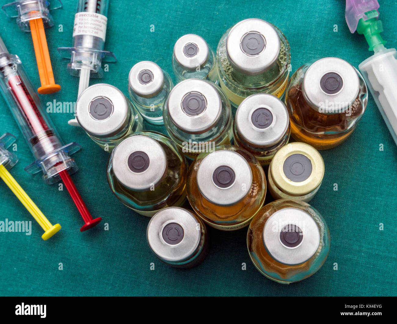 Vials of different size next to syringes at a hospital table ...