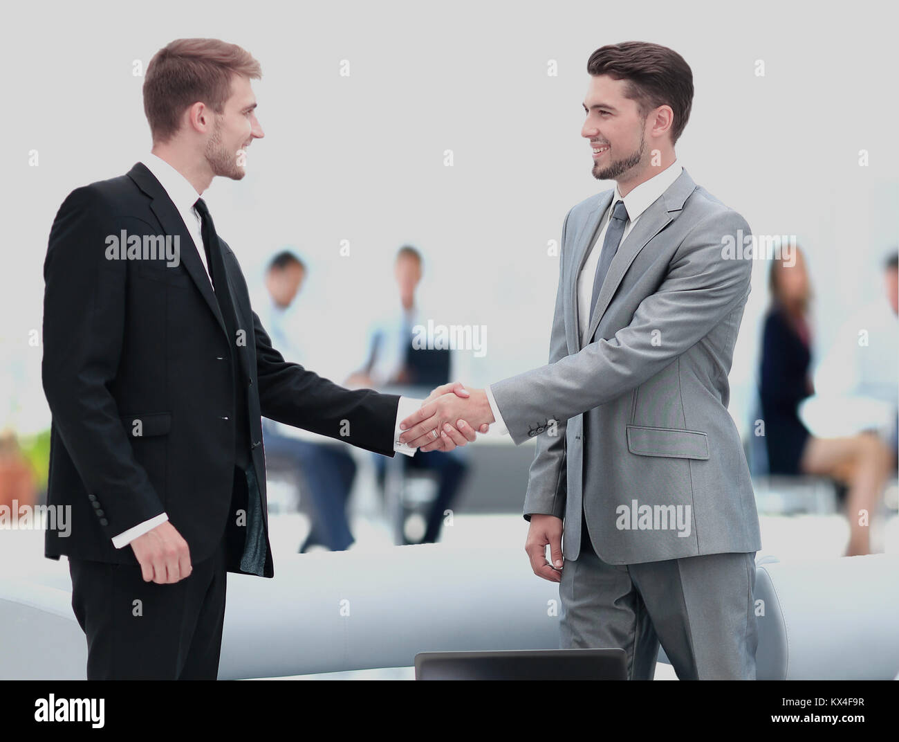 Business people shaking hands during a meeting Stock Photo - Alamy