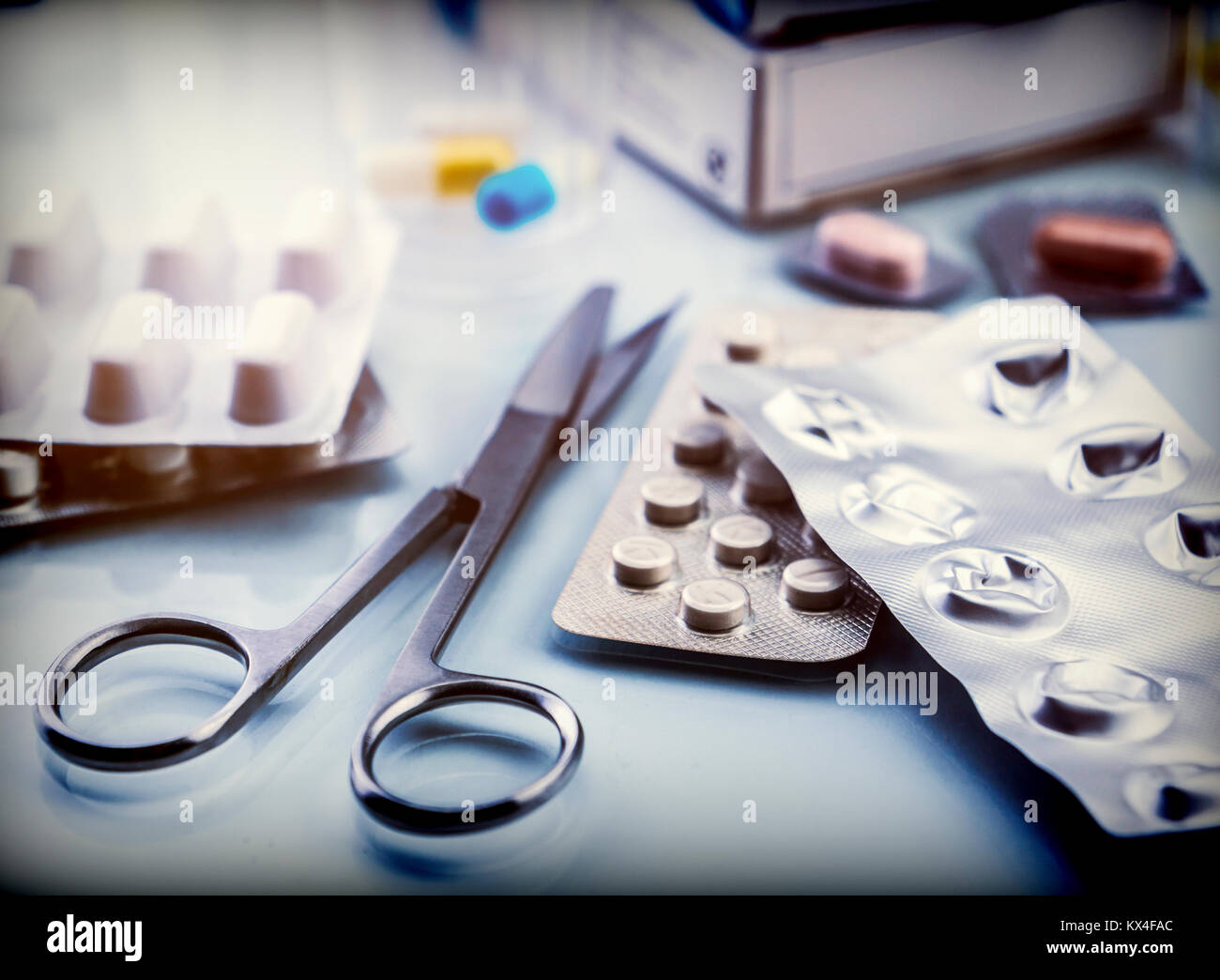 Scissors next to several blister cut, conceptual image Stock Photo - Alamy