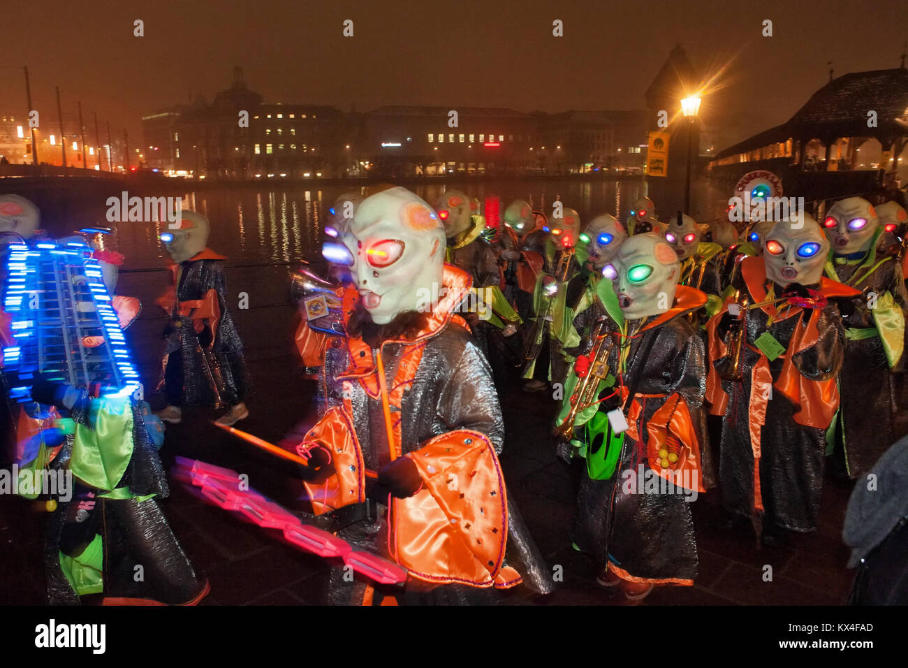 Strange characters with fantastic masks and costumes parade along the ...