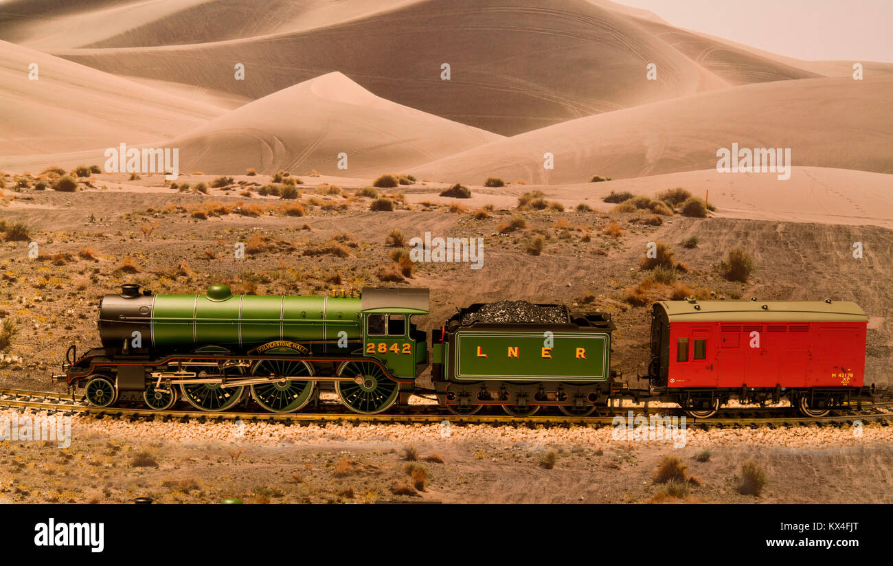 A model of a green steam train set on a scenic background Stock Photo ...