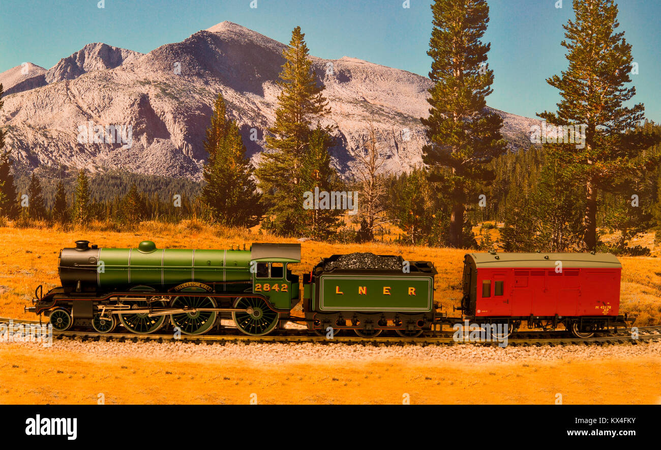 A model of a green steam train set on a scenic background Stock Photo ...