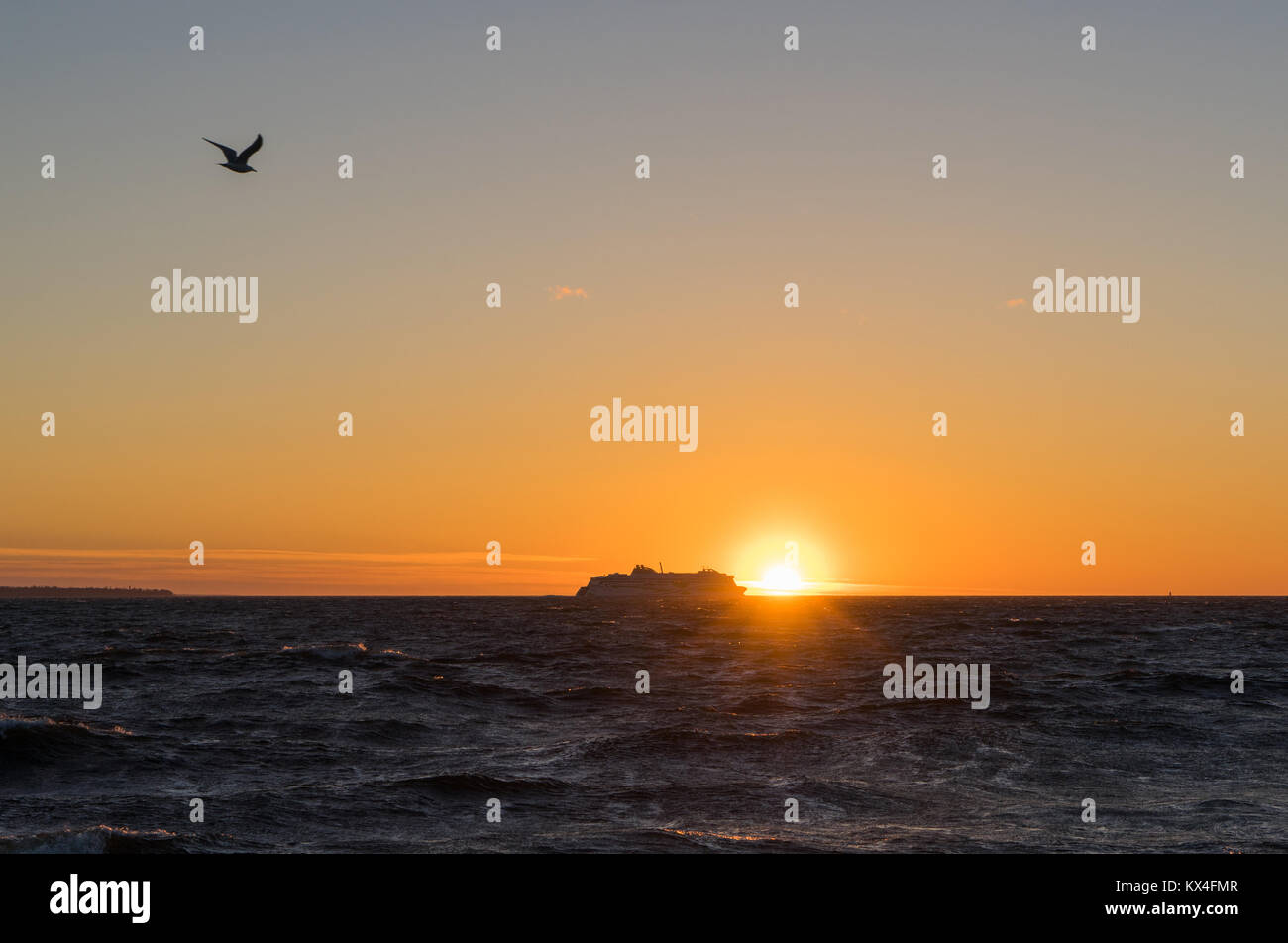 sunset at the sea with ship Stock Photo - Alamy