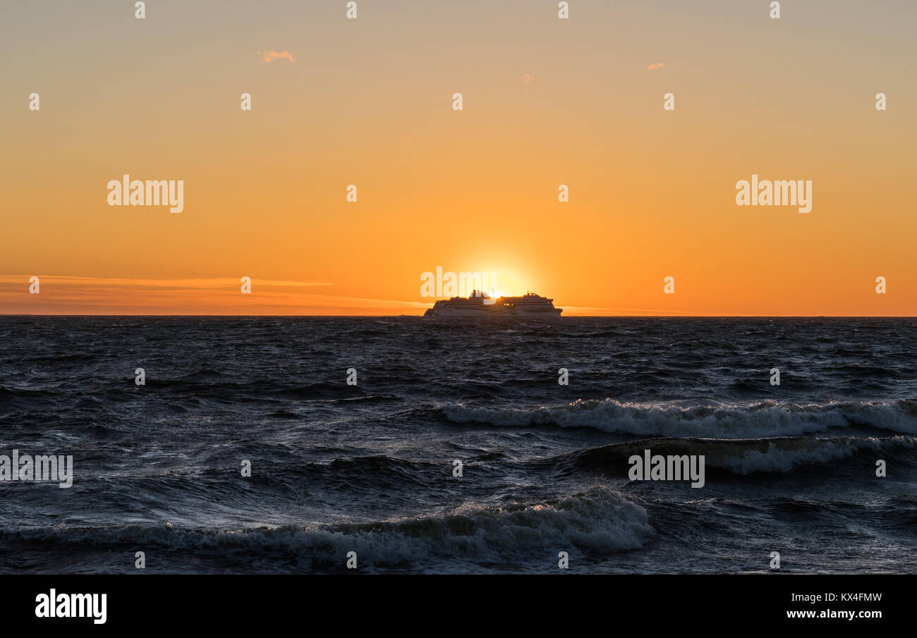 sunset at the sea with ship Stock Photo - Alamy