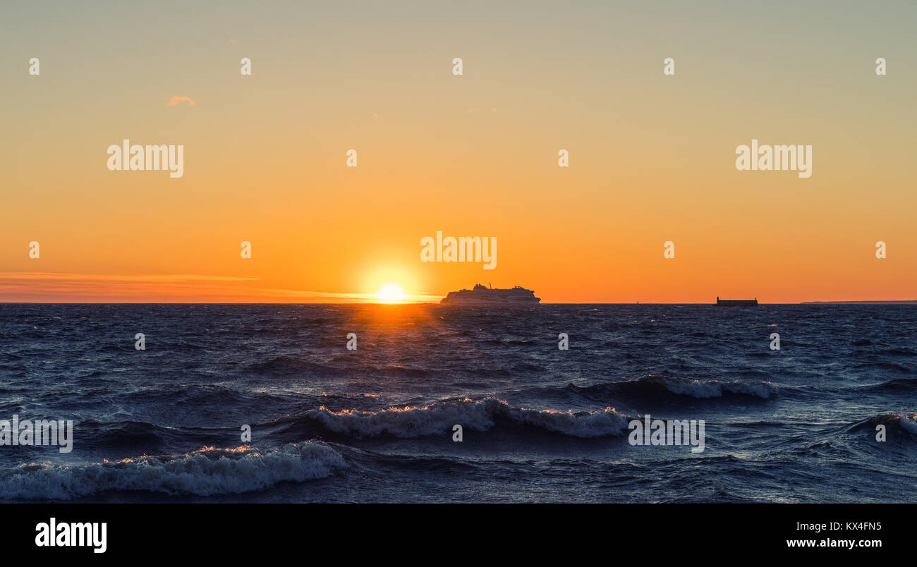 sunset at the sea with ship Stock Photo - Alamy