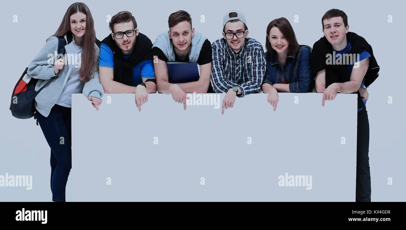 Full length portrait of confident college students displaying blank ...