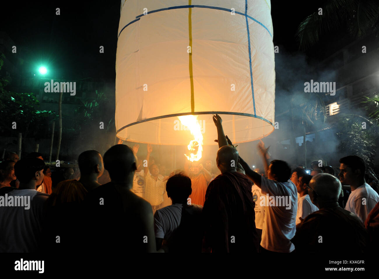 DHAKA, BANGLADESH-OCTOBER 27, 2015: Buddha people flying paper lantern ...