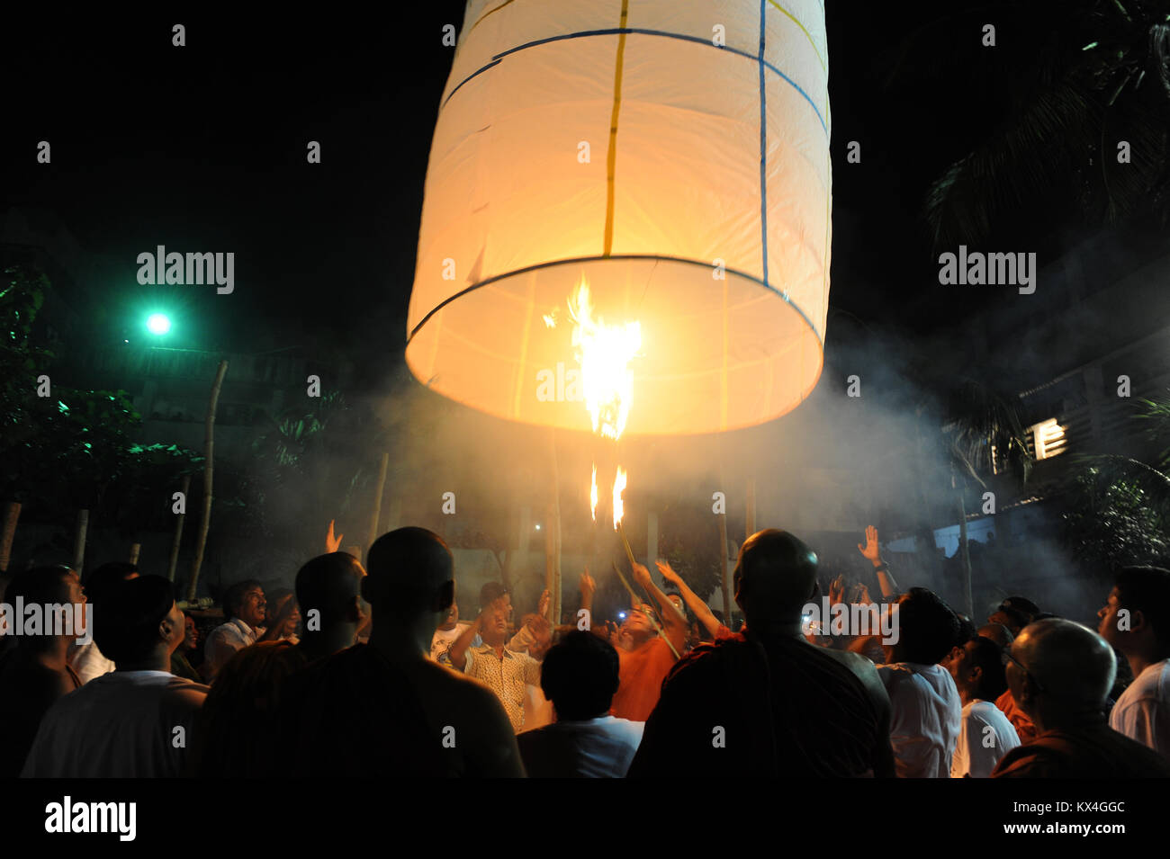 DHAKA, BANGLADESH-OCTOBER 27, 2015: Buddha people flying paper lantern ...